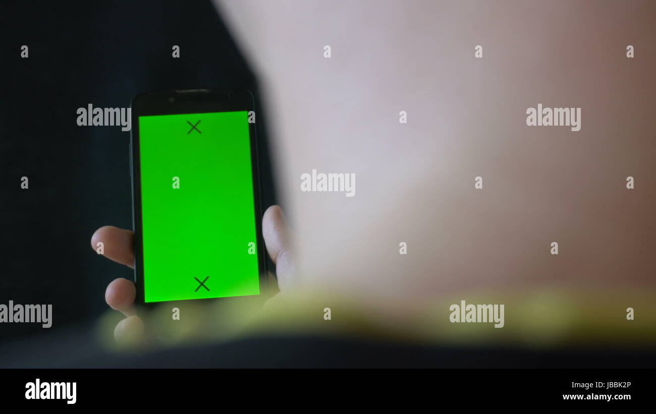 Close-up of male hands touching of smartphone. Green screen Chroma Key ...