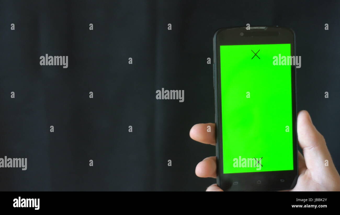 Close-up of male hands touching of smartphone. Green screen Chroma Key ...