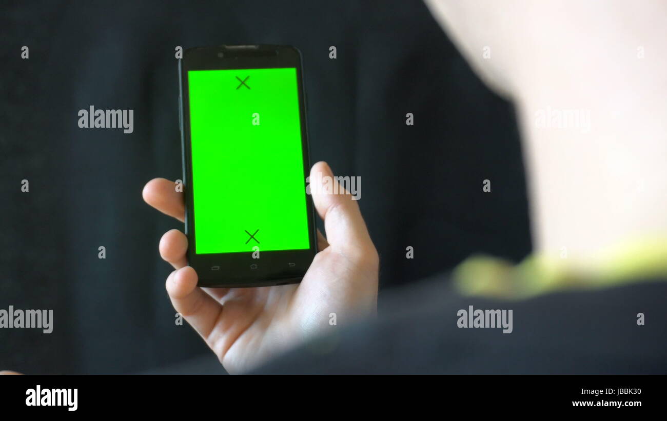 Close-up of male hands touching of smartphone. Green screen Chroma Key ...