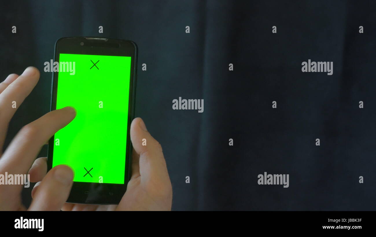 Close-up of male hands touching of smartphone. Green screen Chroma Key ...