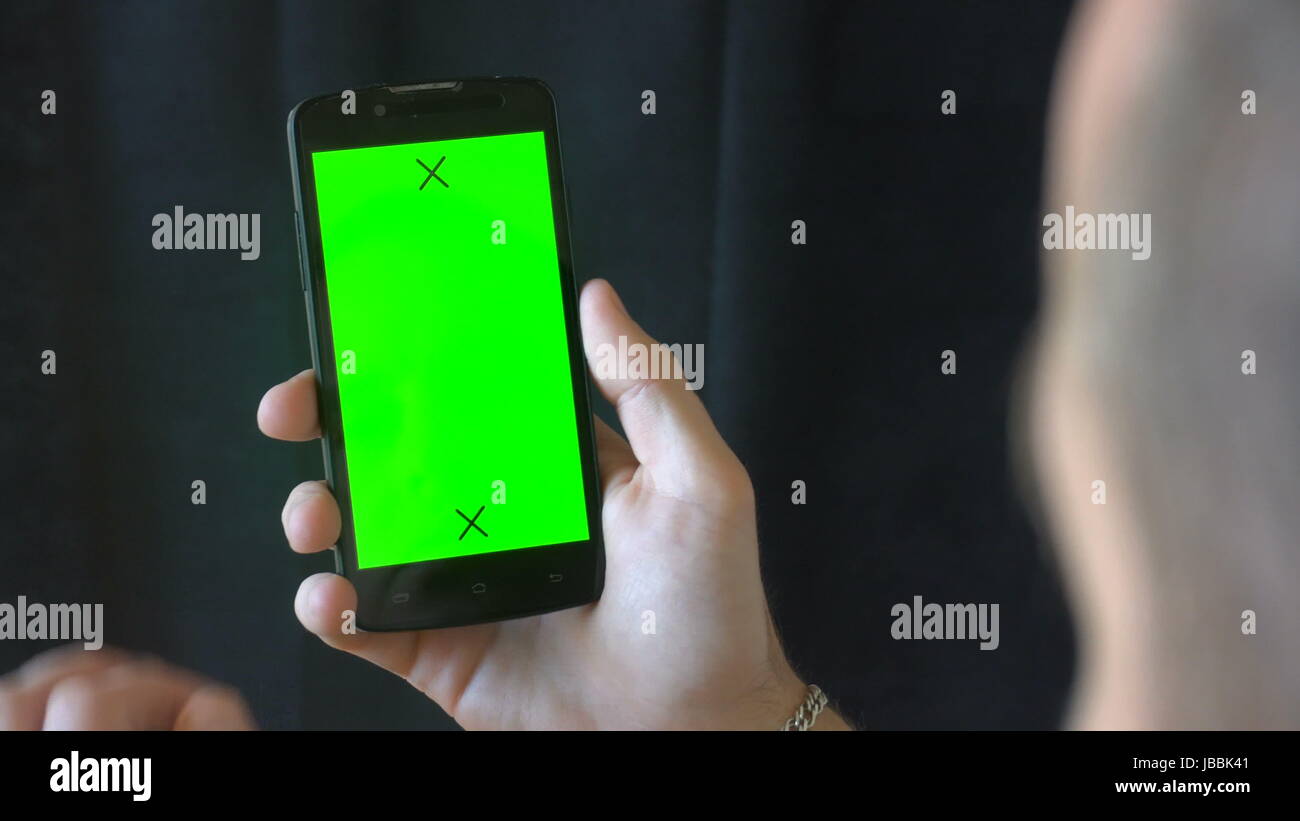 Close-up of male hands touching of smartphone. Green screen Chroma Key ...