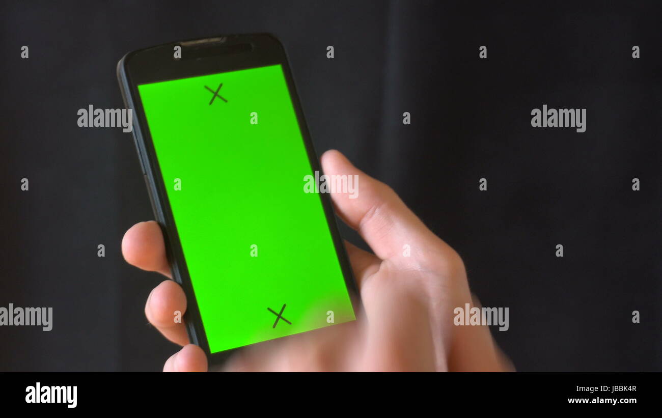 Close-up of male hands touching of smartphone. Green screen Chroma Key ...