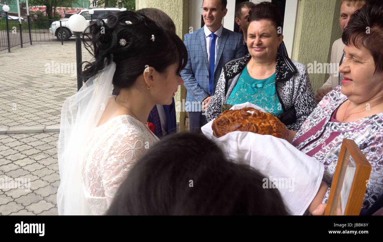 Kursk, Russia - June 3, 2017: the bride and groom bite the bread ...