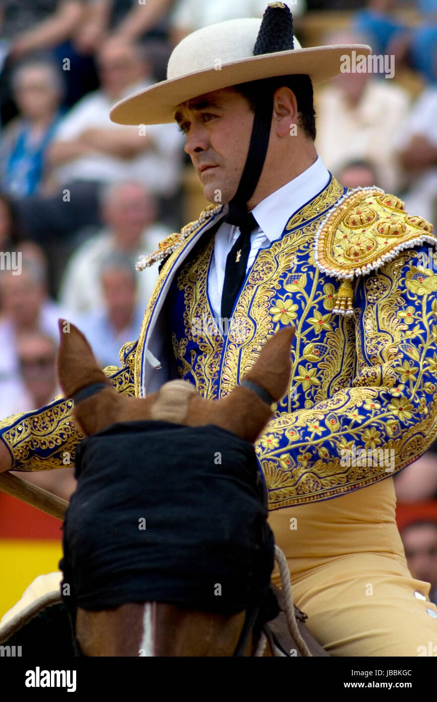 A lancer waits the bull riding his horse Stock Photo - Alamy