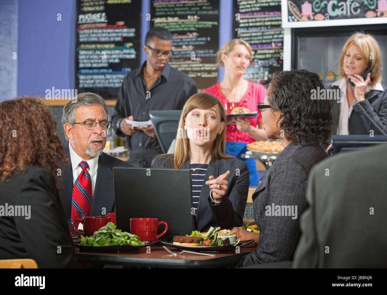 Adult business people in conversation during lunch break Stock Photo ...