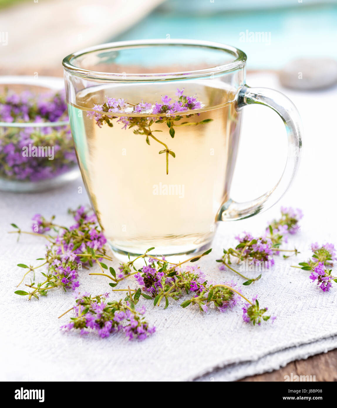 Cup of herbal thyme tea with fresh herb flowers Stock Photo - Alamy