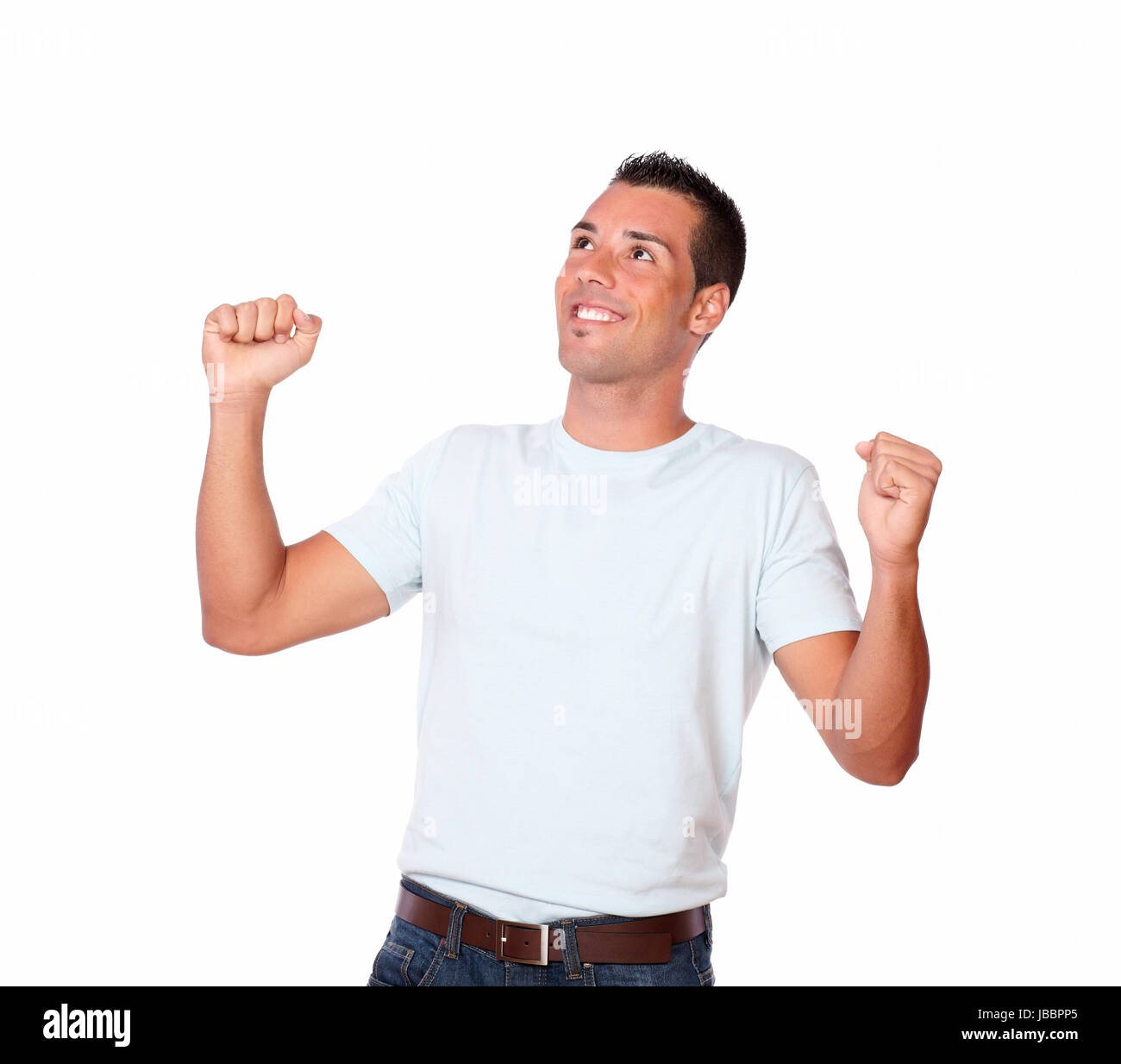 Portrait of an attractive young man celebrating his victory while ...