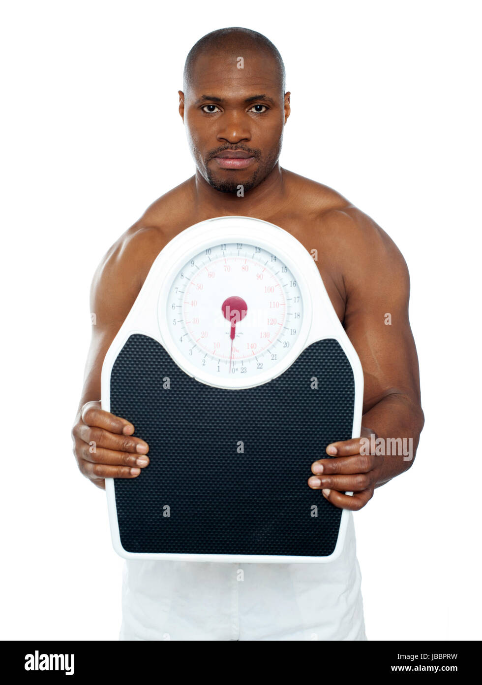 Attractive athlete showing weighing scale against white background ...