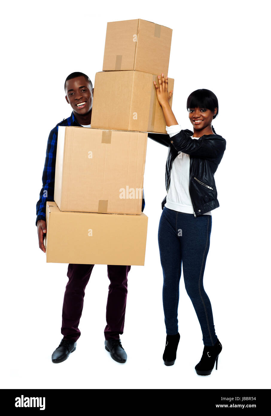 Attractive young couple standing with cardboard boxes. Smiling at ...
