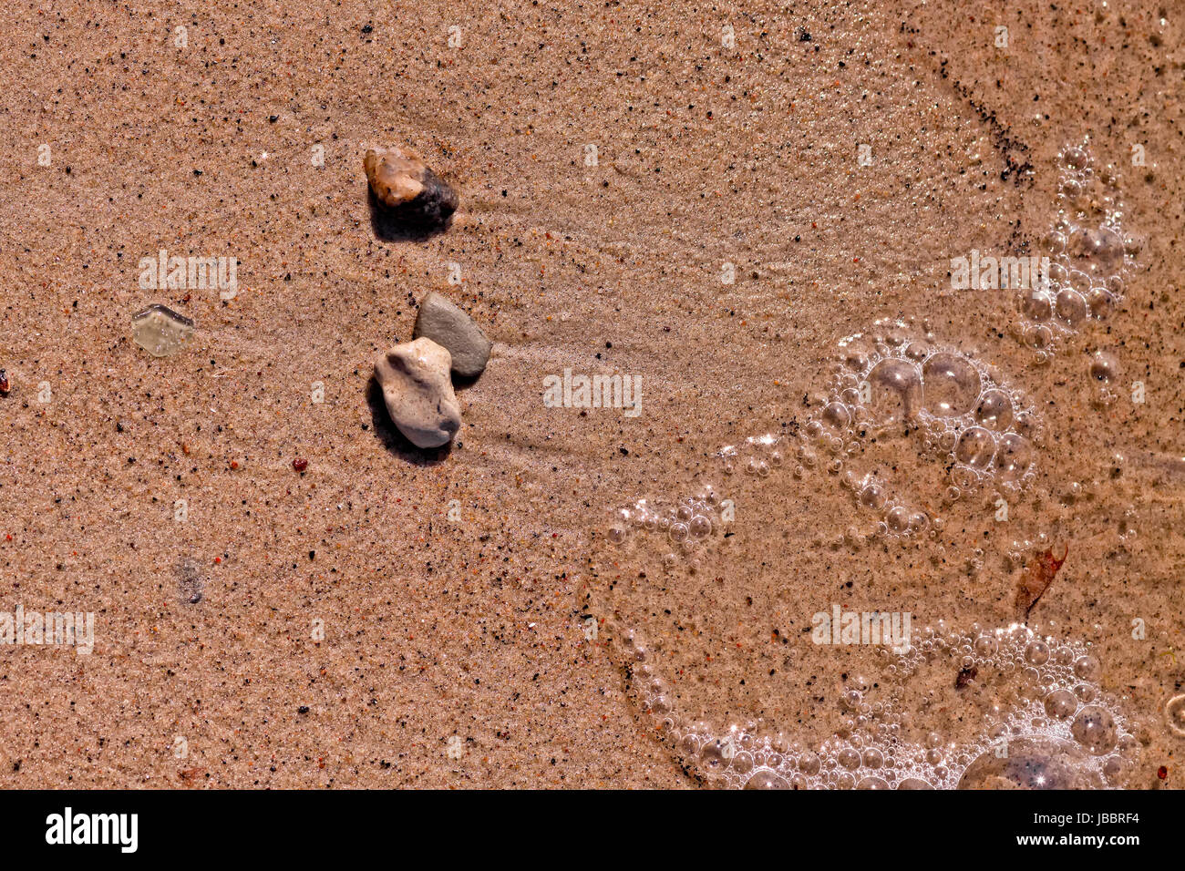 The water of the Baltic sea washes the pebbles on the Pirita beach in ...