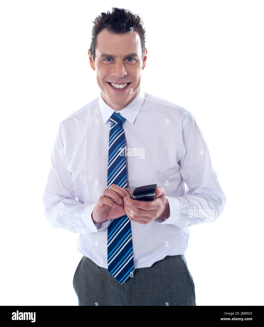 Business professional messaging while smiling at camera Stock Photo - Alamy