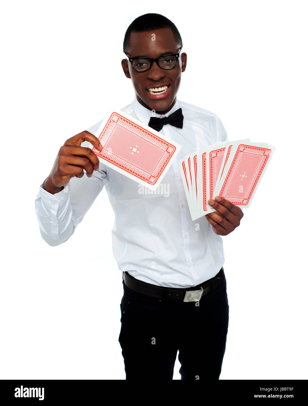 Young black boy holding out deck of cards and throwing his trump card ...