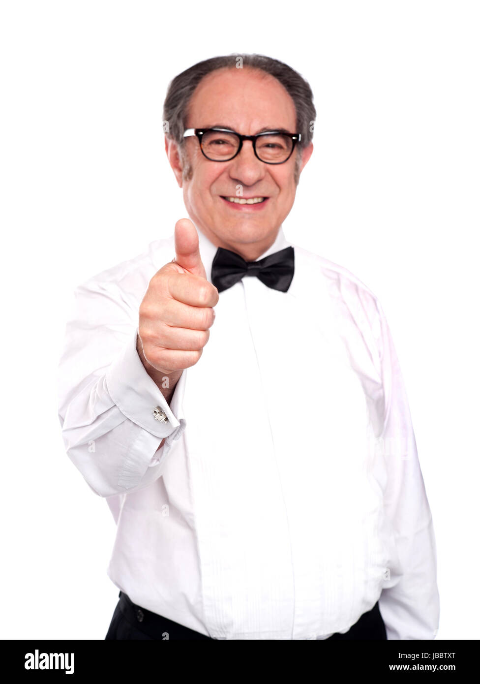 Smiling old man gesturing thumbs up against white background Stock ...
