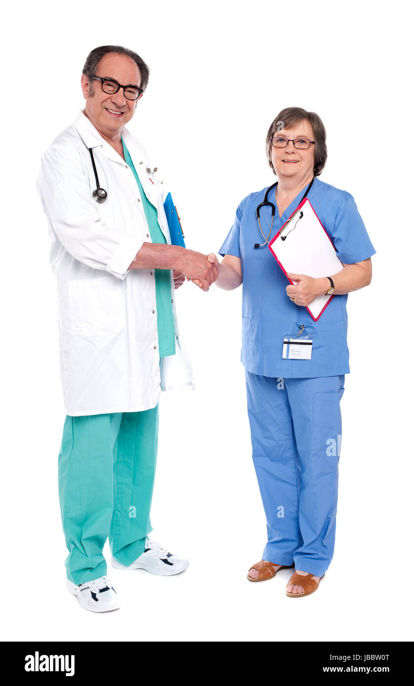 Full body portrait of two medical representatives shaking hands Stock ...