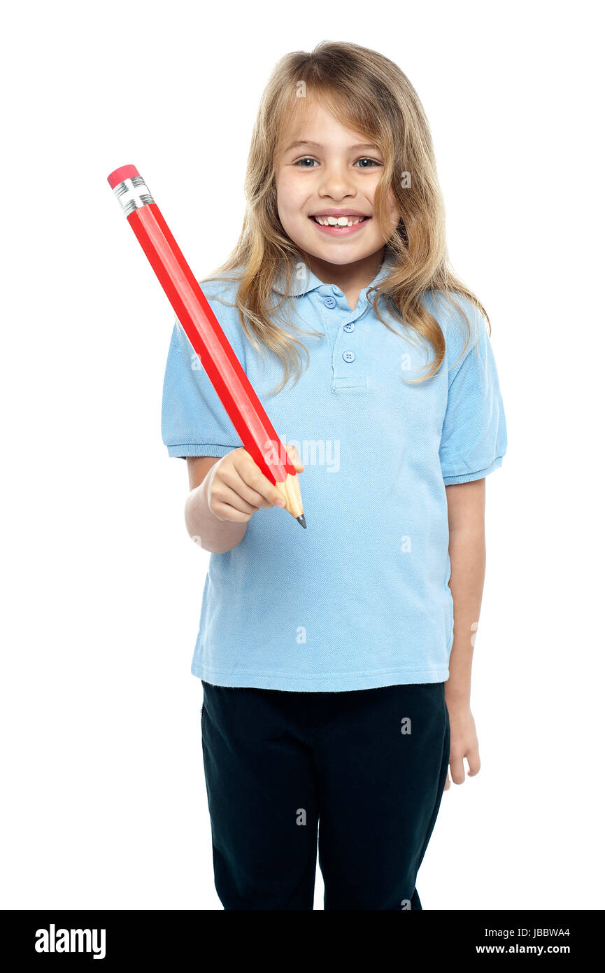 Smiling schoolkid holding big red pencil over white background Stock ...