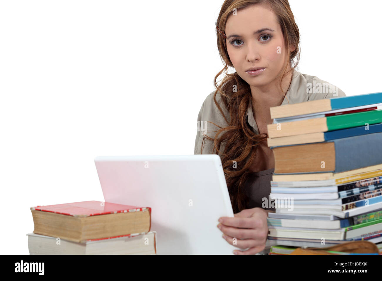 female student with pile of books and laptop Stock Photo - Alamy
