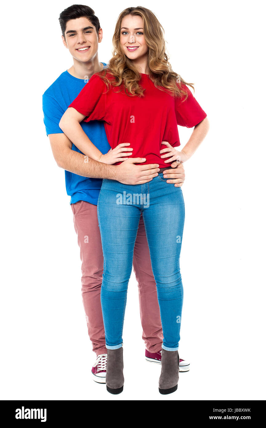 Handsome Young Man Embracing His Girlfriend From Behind Arms Around