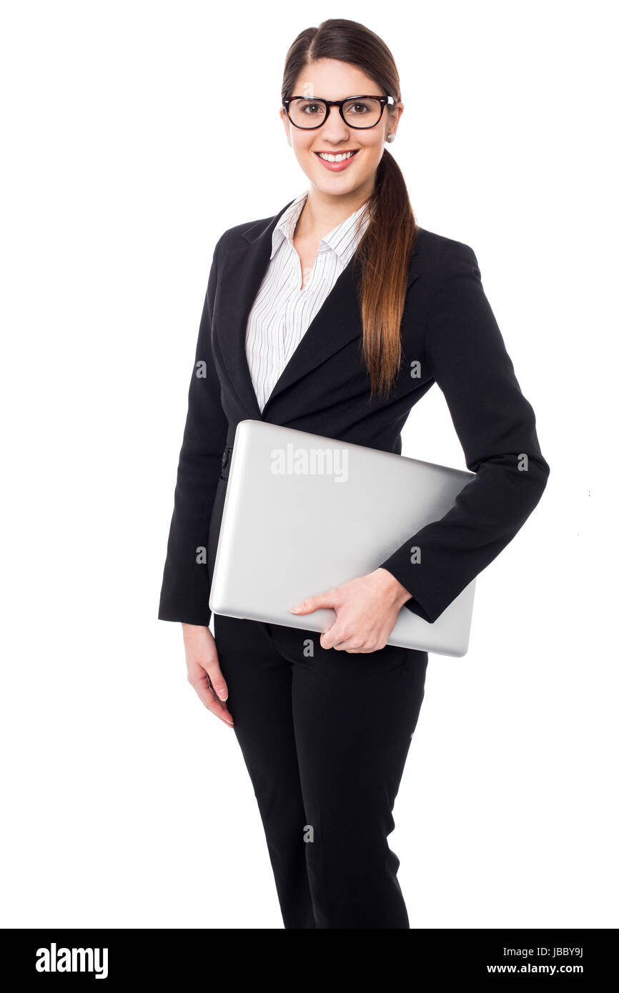 Bespectacled business executive holding laptop Stock Photo - Alamy