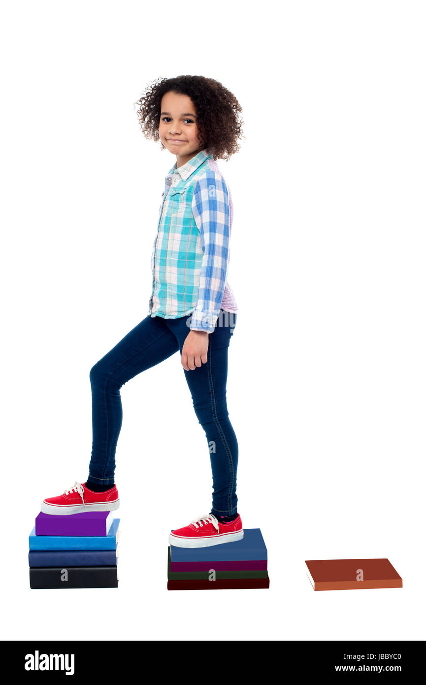 Smart active girl kid climbing notebooks ladder Stock Photo - Alamy