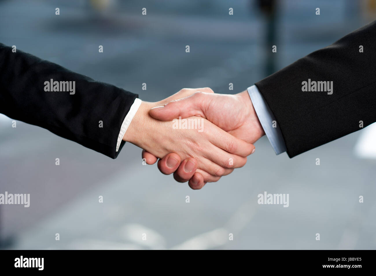 Successful business people shaking hands after closing a deal Stock ...