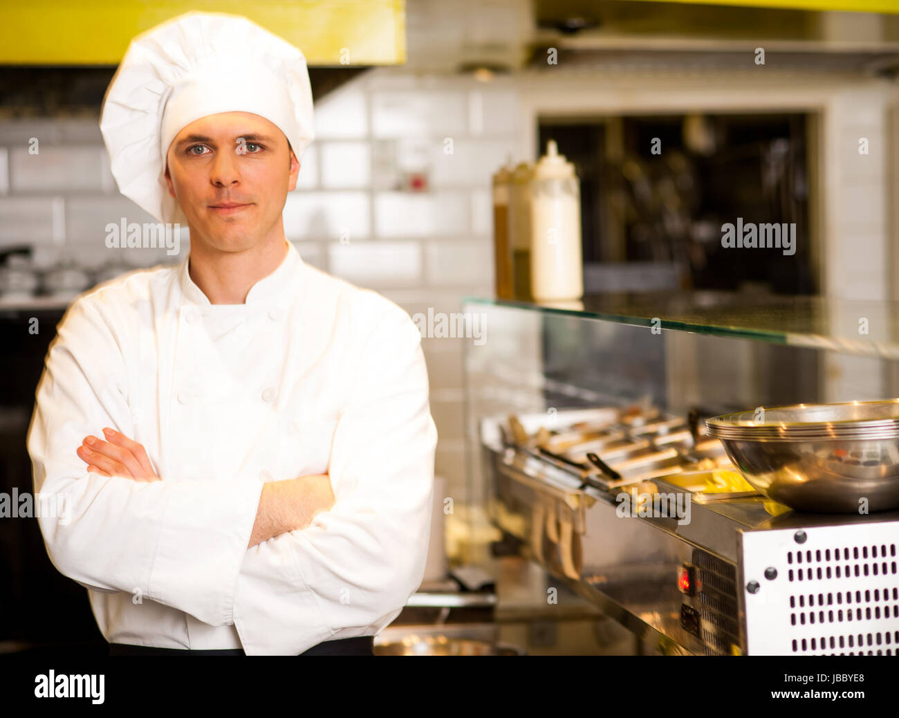 Handsome and confident young male chef, kitchen background Stock Photo ...