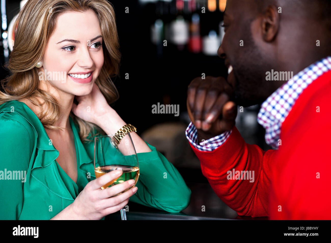 Young couple enjoying at bar, busy in romantic conversation Stock Photo ...