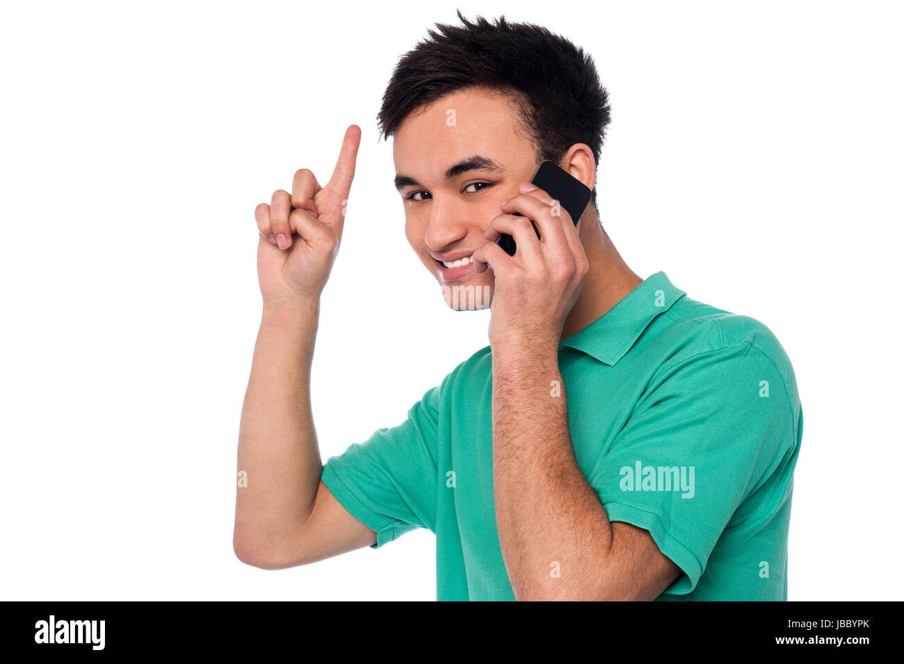 Cheerful young guy communicating via mobile studio shot Stock Photo - Alamy