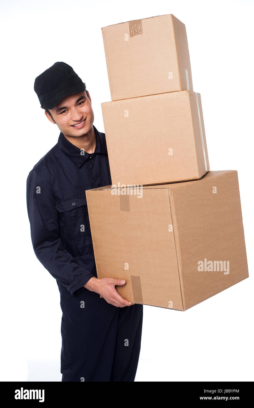 Young delivery boy holding stack of parcel boxes Stock Photo - Alamy