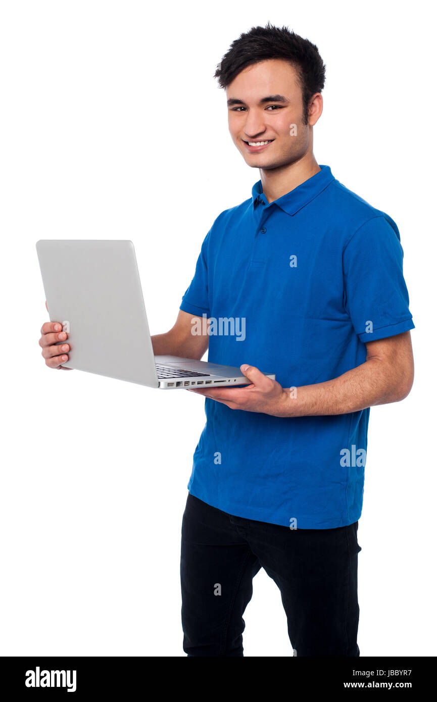 Young guy holding his new laptop, isolated over white Stock Photo - Alamy