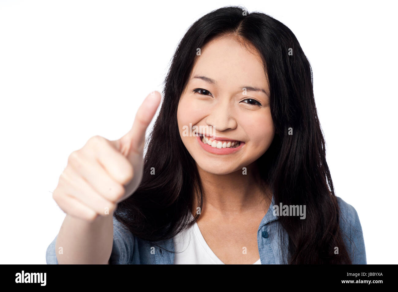 Young smiling girl showing thumbs up Stock Photo - Alamy