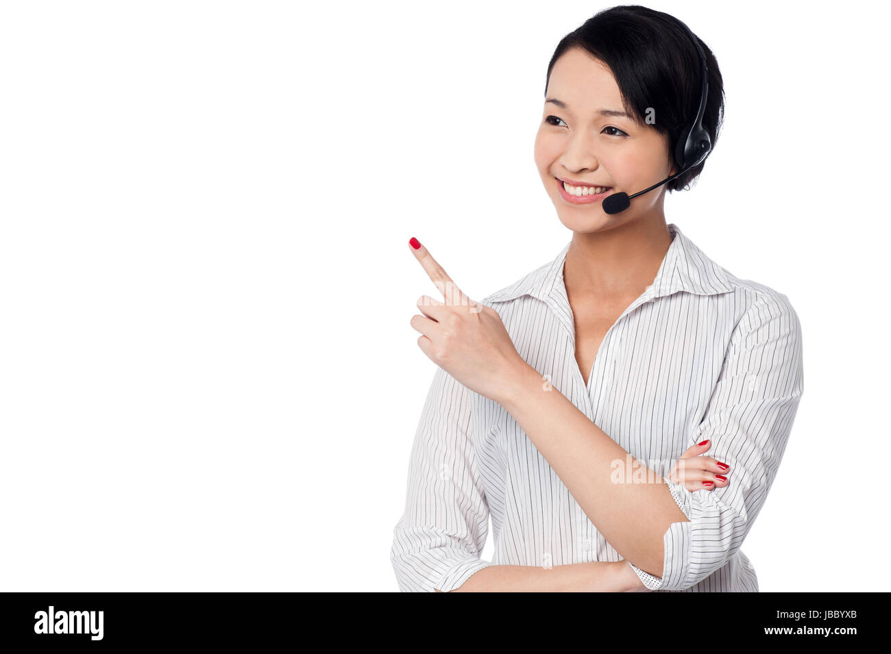 Young support staff pointing towards copy space area Stock Photo - Alamy