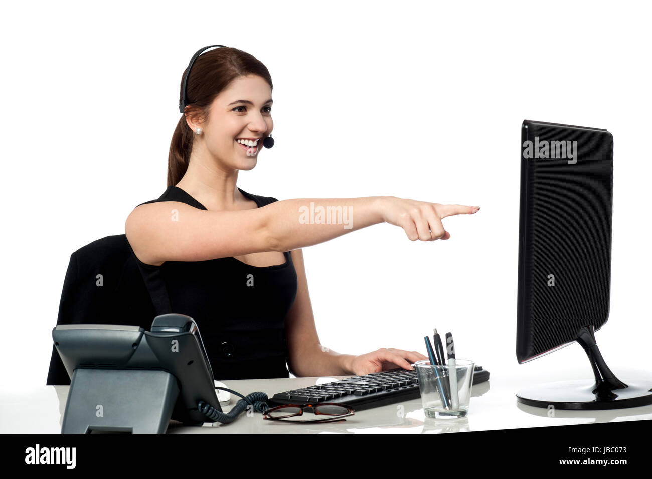 Female staff pointing her finger at computer screen Stock Photo - Alamy