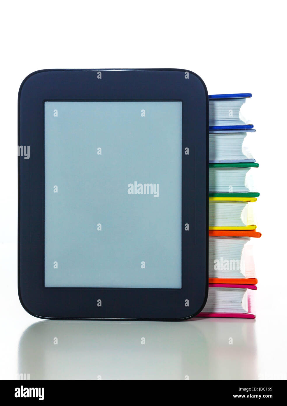 Electronic book reader with a pile of hard cover books Stock Photo - Alamy