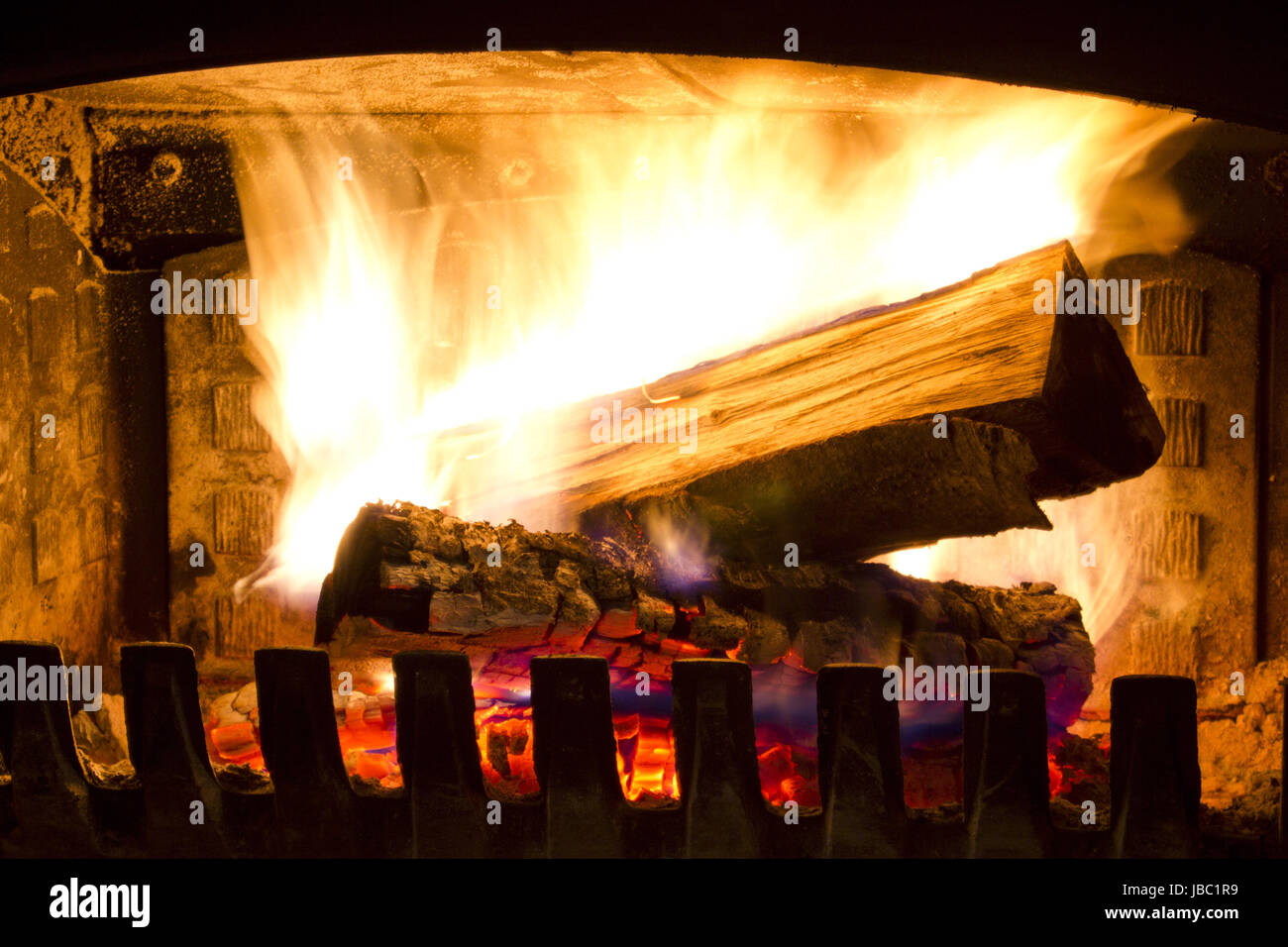 Fire place detail of a fire burning inside Stock Photo - Alamy