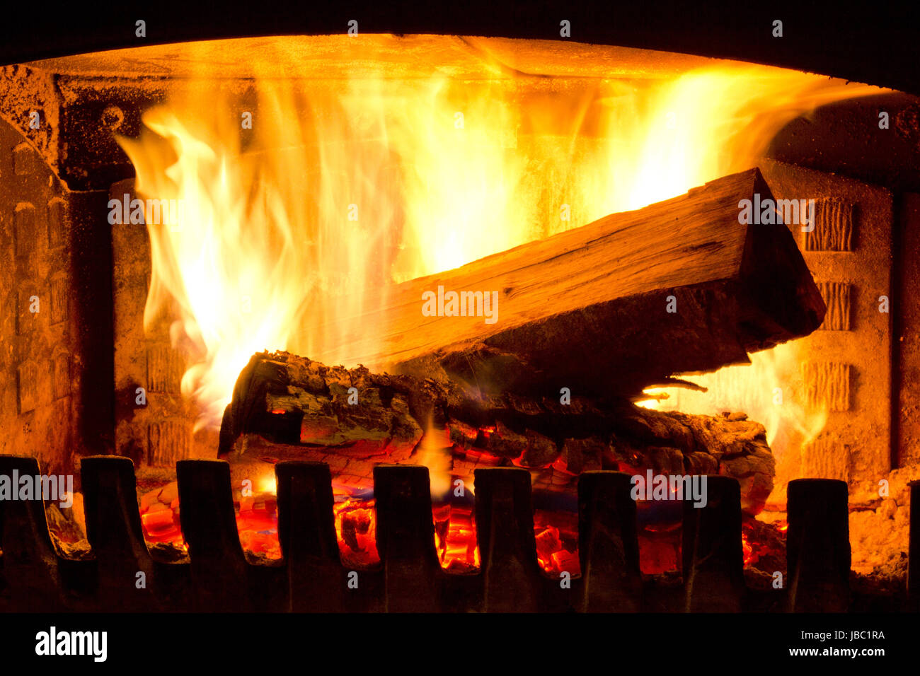 Fire place detail of a fire burning inside Stock Photo - Alamy