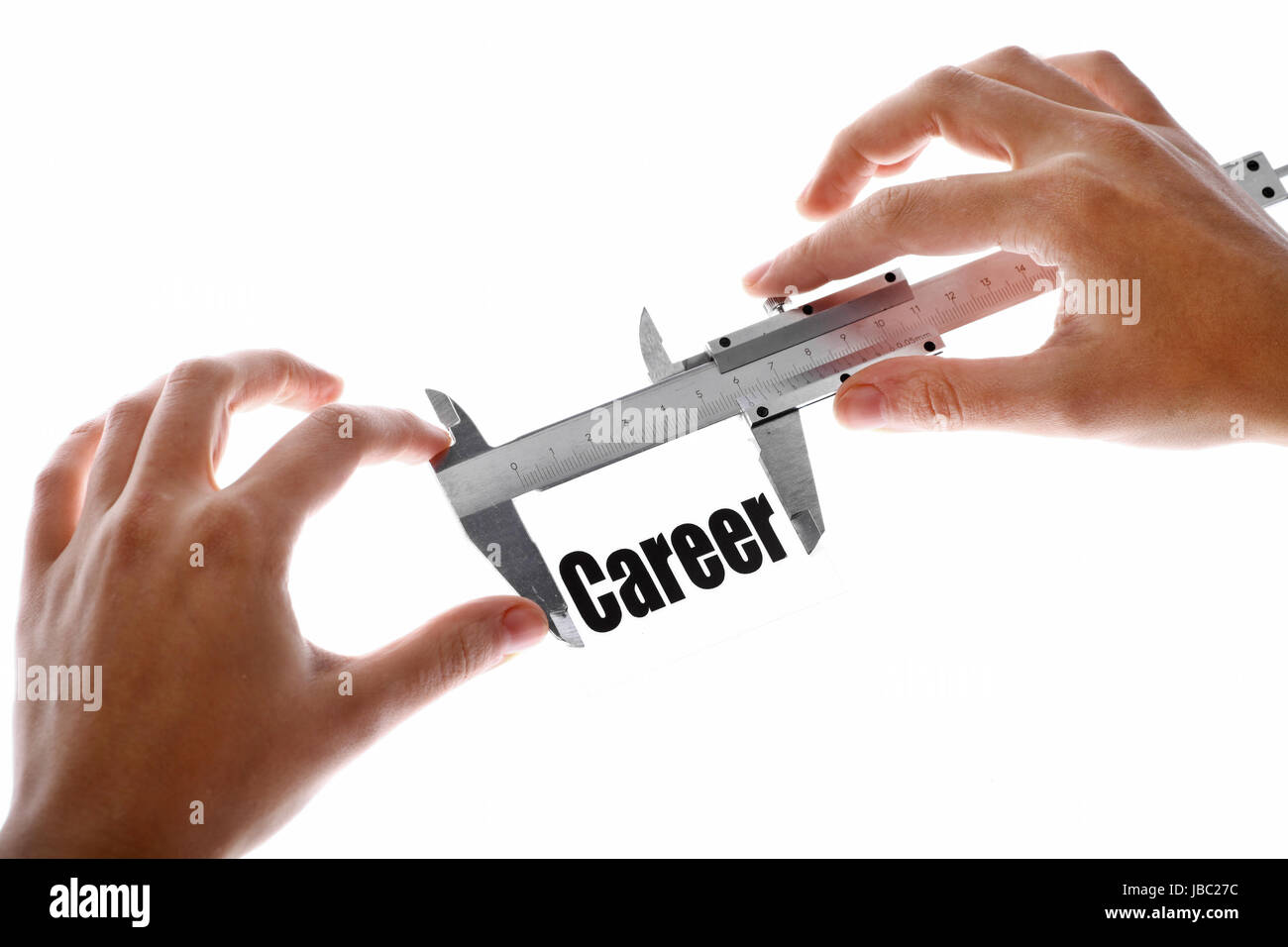 Two hands holding a caliper, measuring the word "Career Stock Photo - Alamy