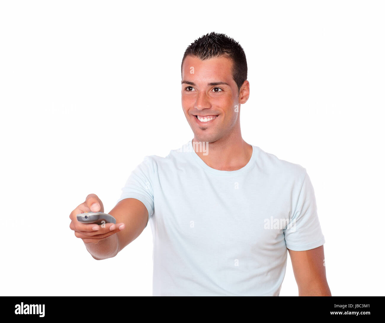 Portrait of a gorgeous man pointing with remote control while looking ...