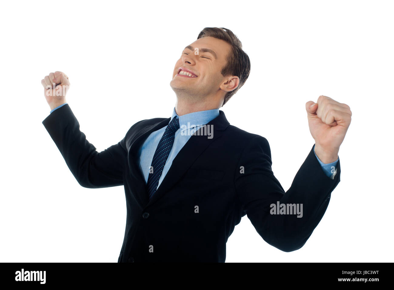 Excited successful businessman looking up against white background ...