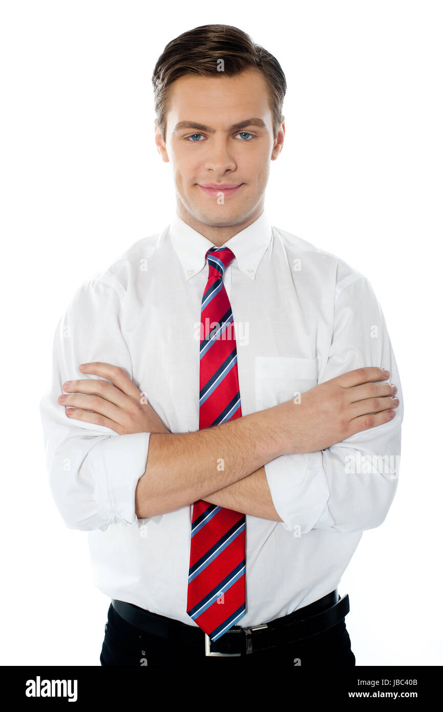Cute young professional male standing with folded arms against white background Stock Photo - Alamy