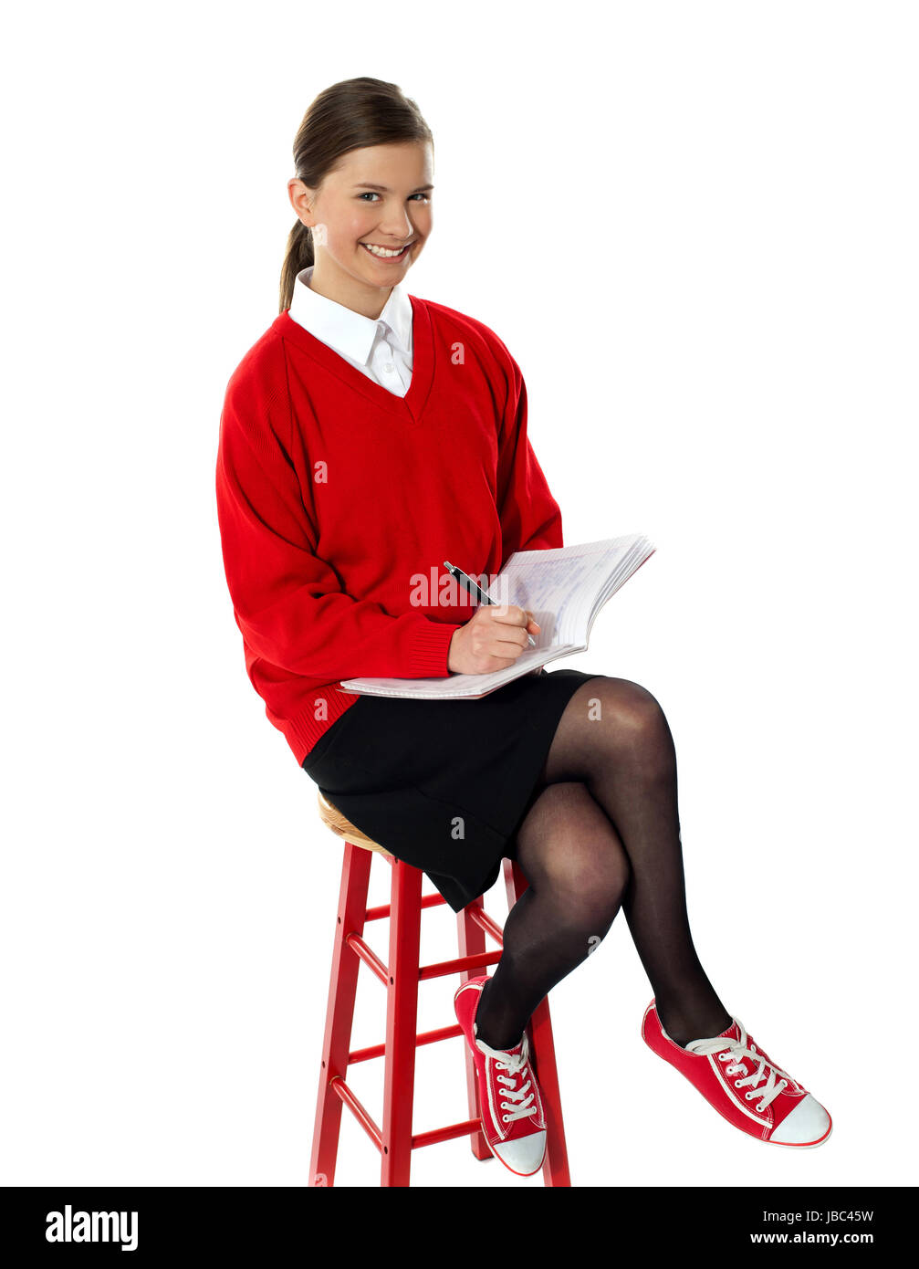 Girl sitting on stool writing hi-res stock photography and images - Alamy