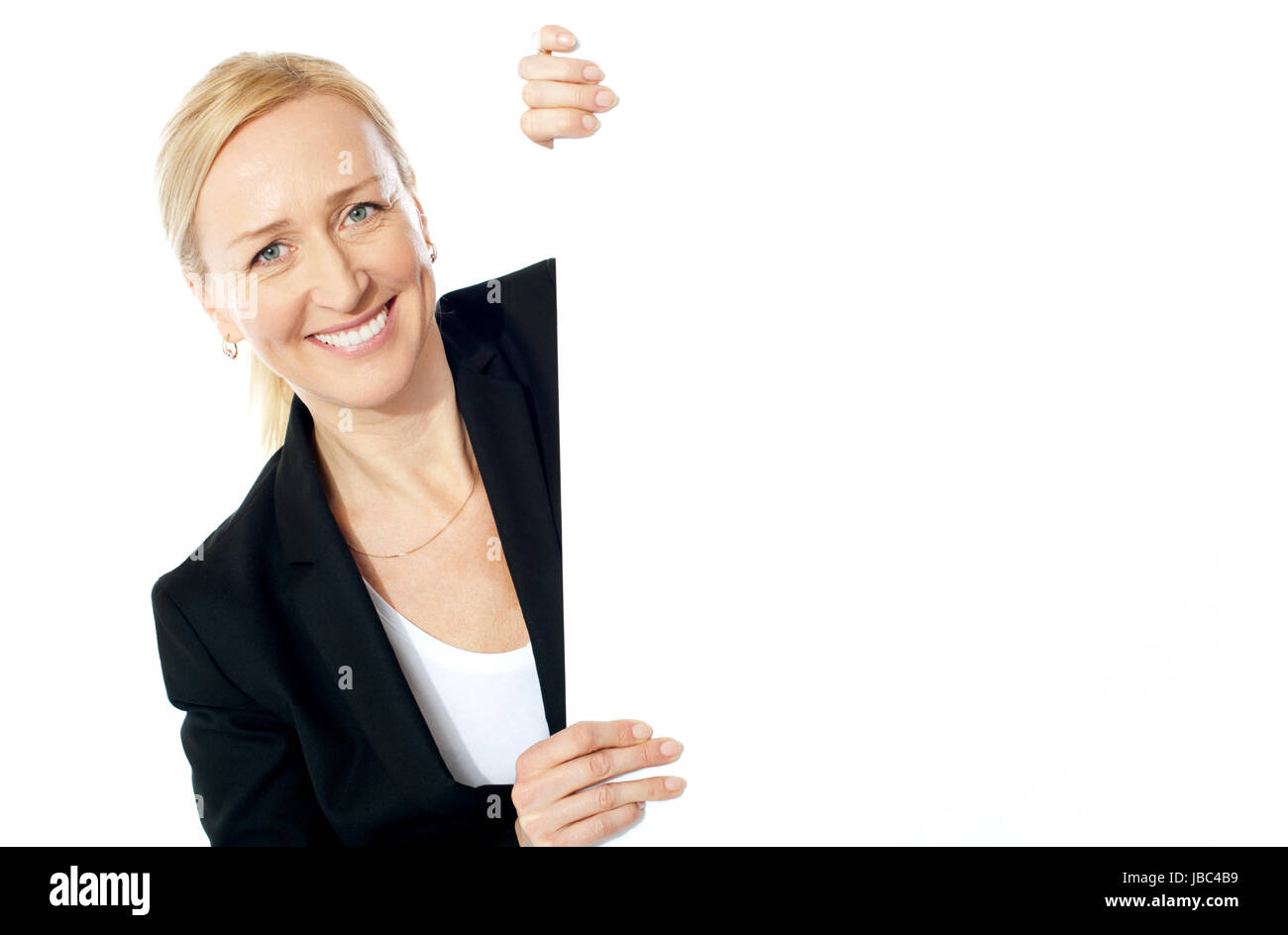 Smiling aged female executive holding clipboard, looking at you Stock ...