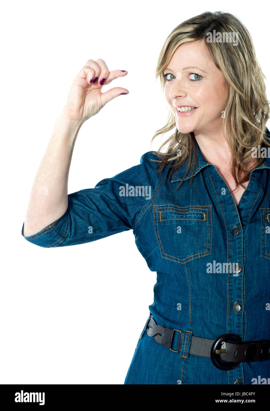Portrait of beautiful woman showing little bit gesture isolated over ...
