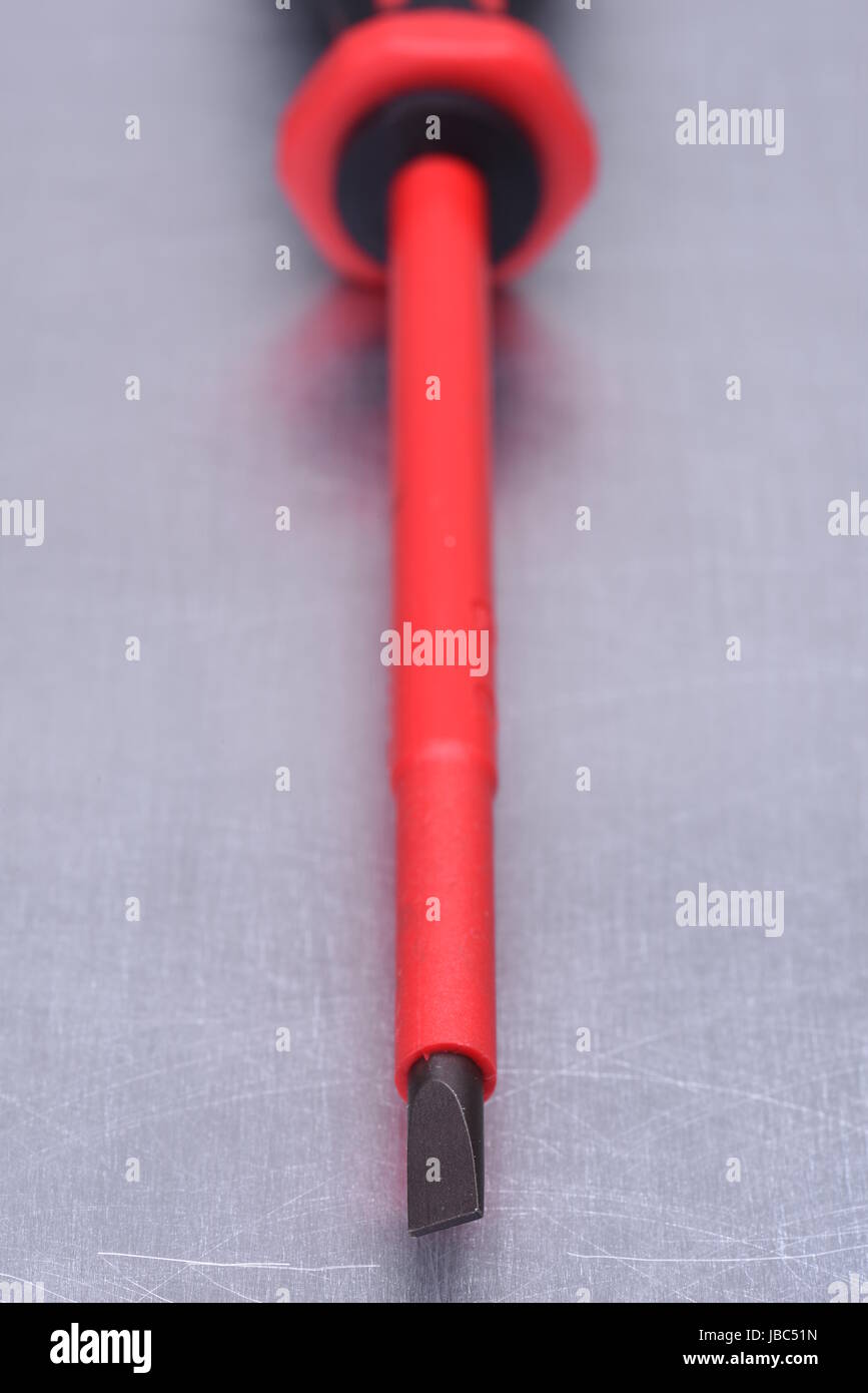 Screwdriver on metal background closeup Stock Photo - Alamy