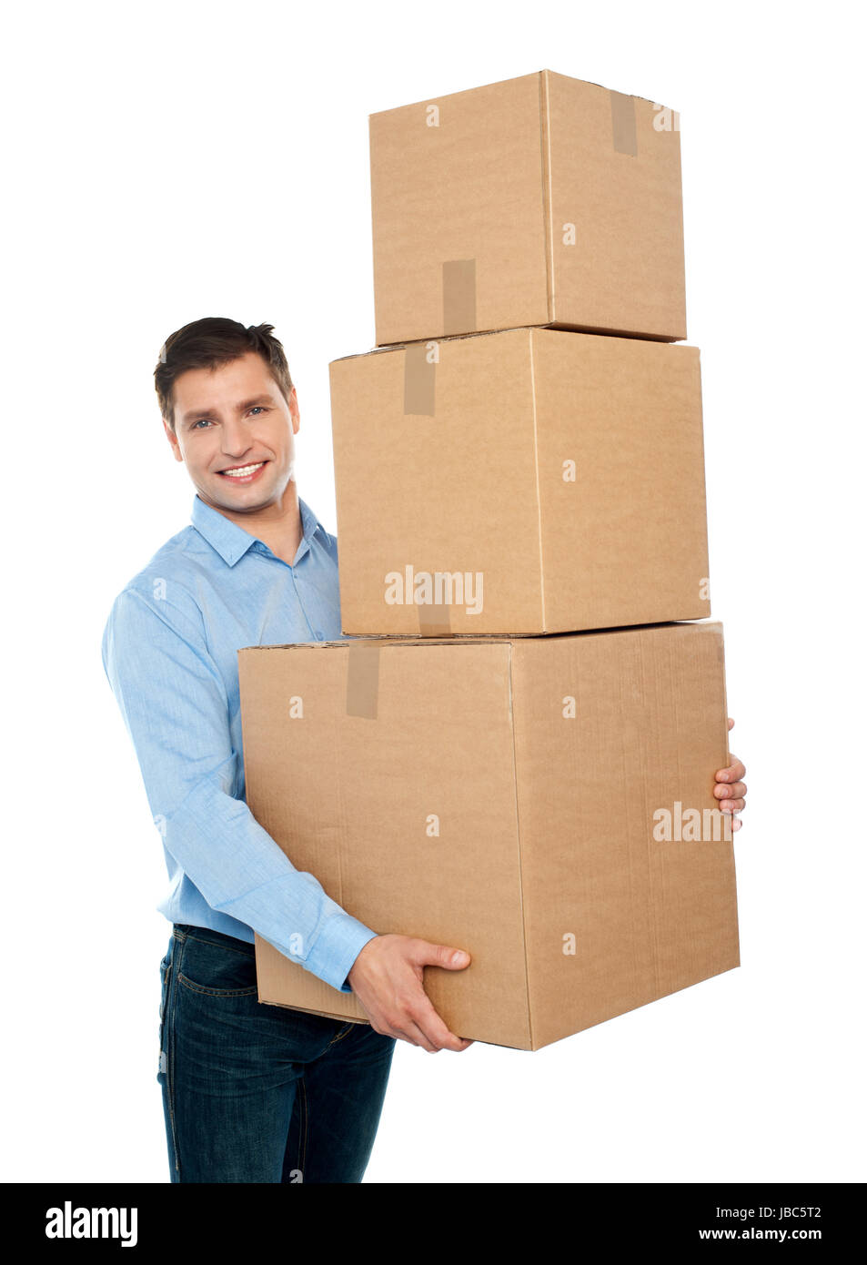 Happy young man carrying heavy packages against white background Stock ...