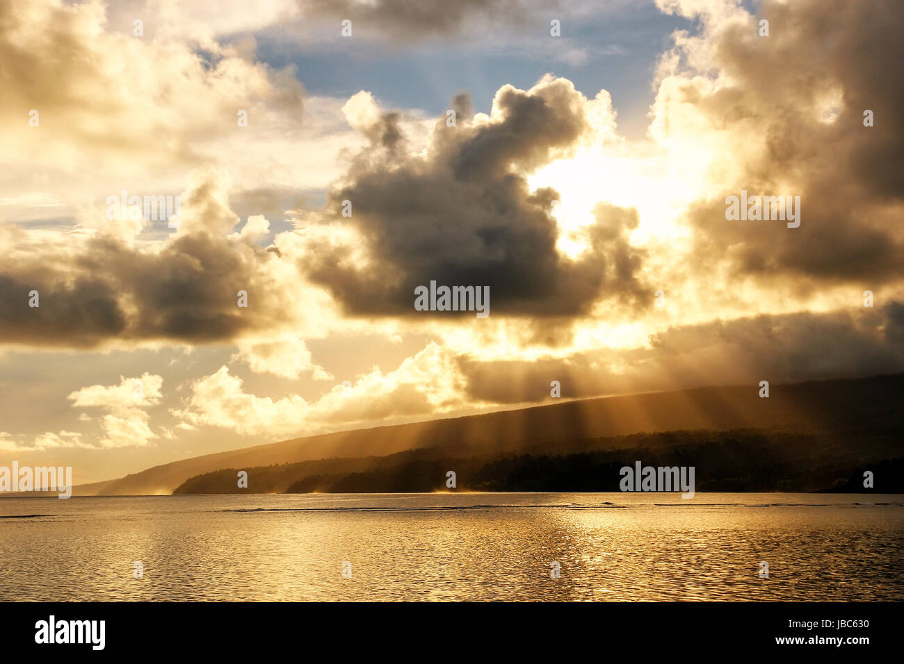 Sunset with rays in Lavena village on Taveuni Island, Fiji. Taveuni is ...