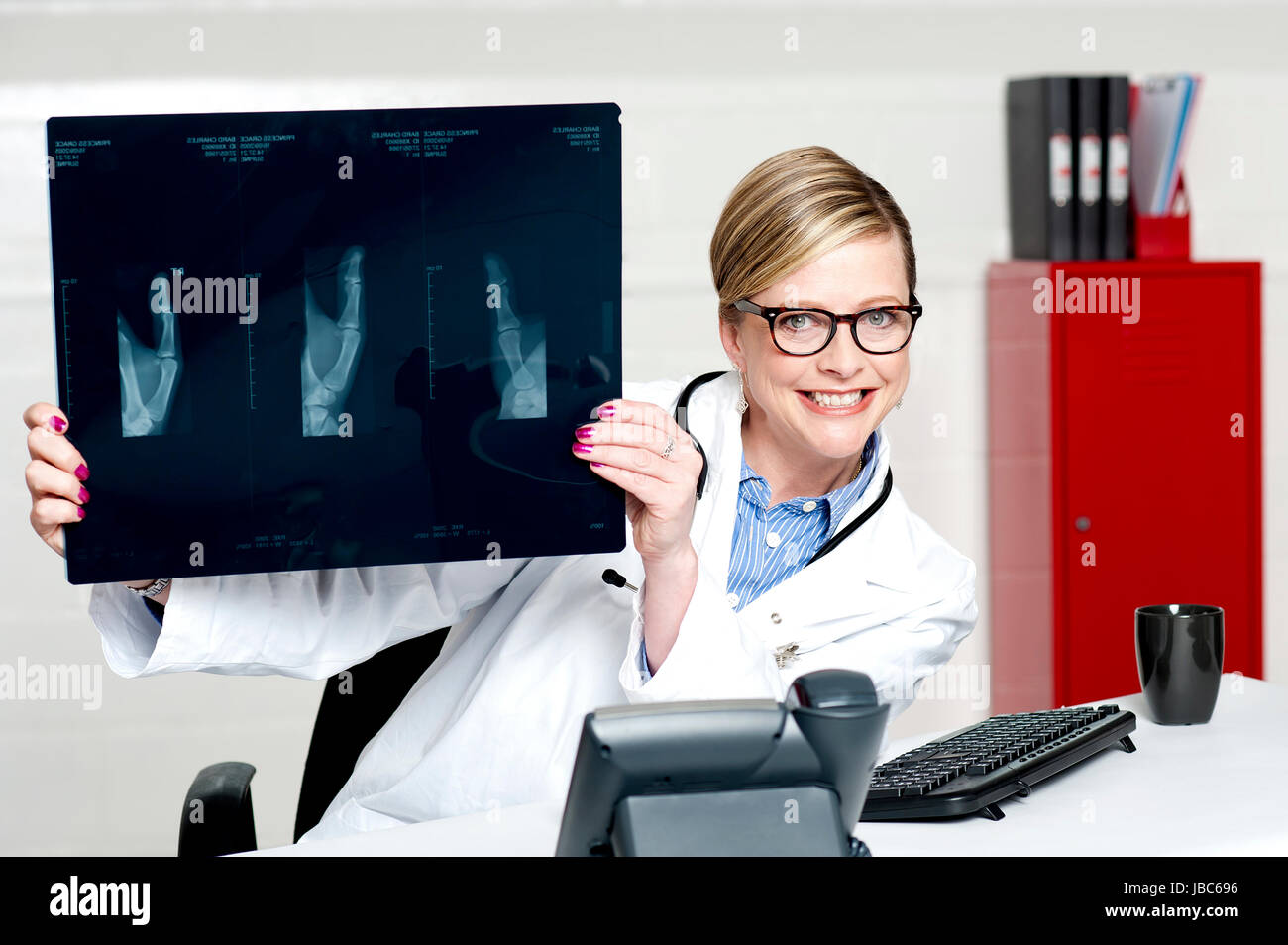 Medical surgeon expert holding x-ray report and showing it to camera ...