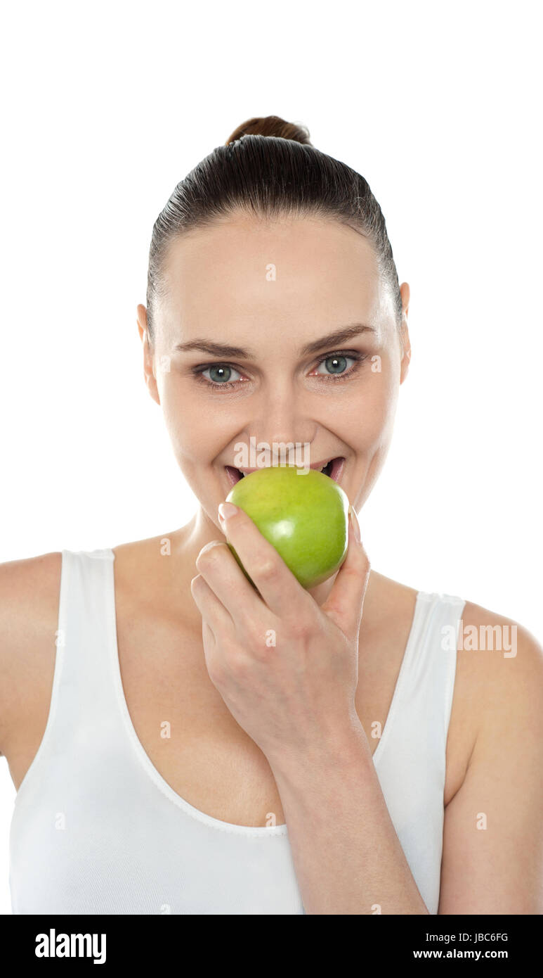 Closeup portrait of beautiful woman eating fresh green apple isolated ...