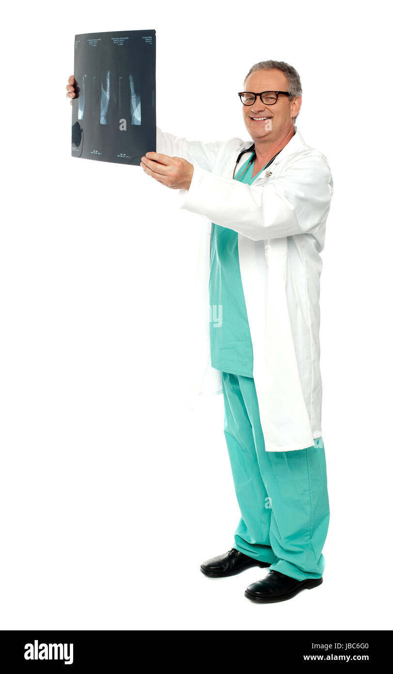 Full length shot of smiling surgeon holding x-ray report of a patient ...