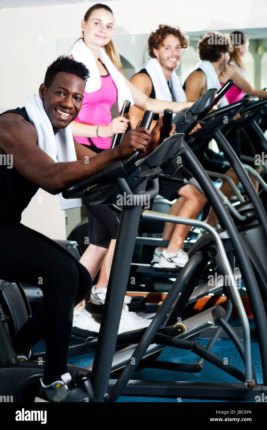 Young group of friends working out together in a gym Stock Photo - Alamy