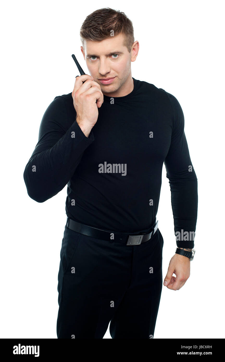 Bouncer guy communicating with his walkie-talkie isolated against white ...